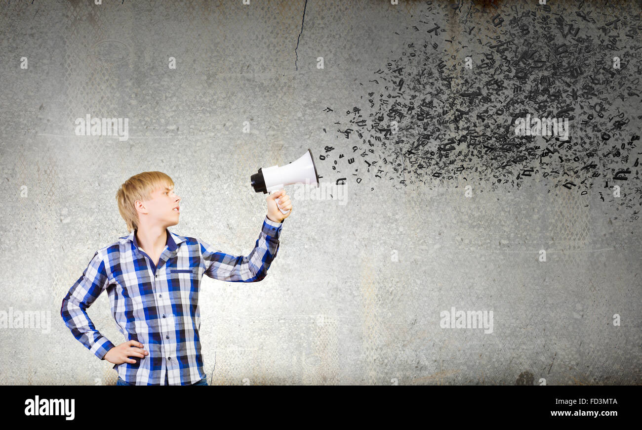 Young man in casual announcing something in megaphone Stock Photo - Alamy