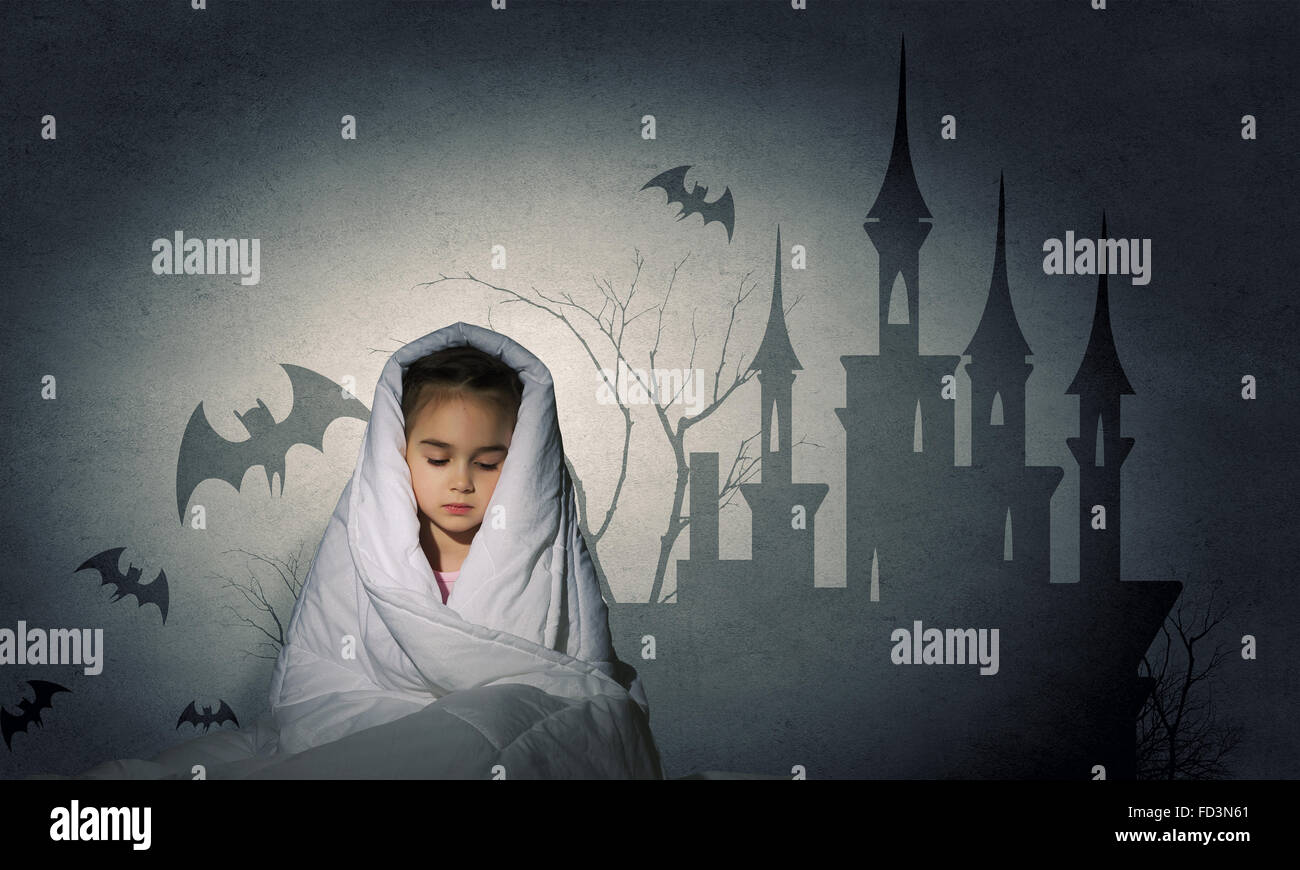 Cute scared girl sitting in bed under blanket Stock Photo - Alamy