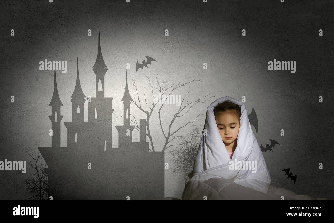 Cute scared girl sitting in bed under blanket Stock Photo - Alamy