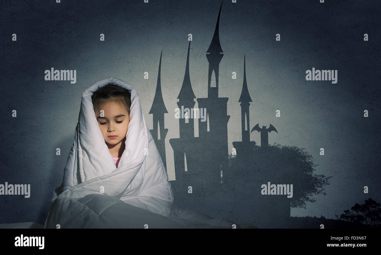 Cute scared girl sitting in bed under blanket Stock Photo - Alamy