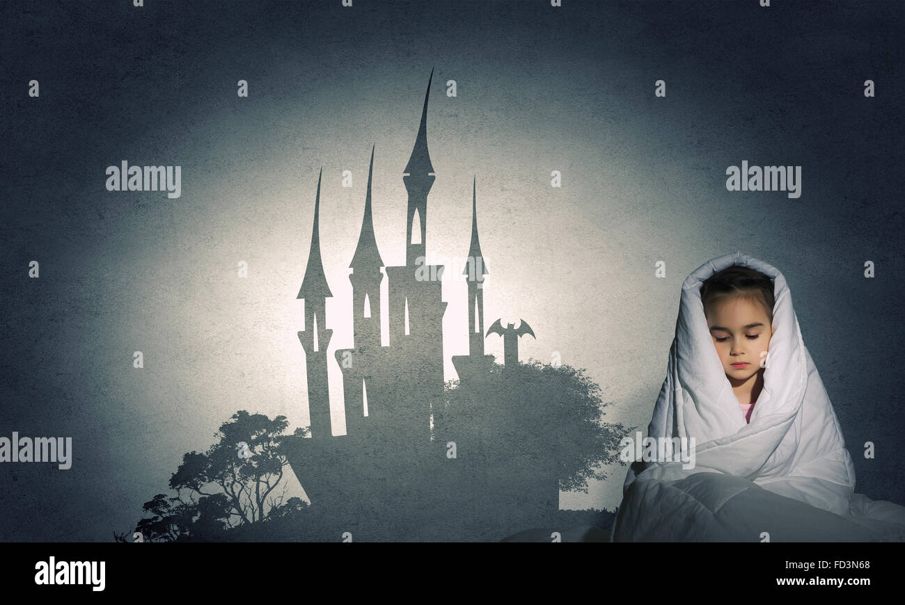 Cute scared girl sitting in bed under blanket Stock Photo - Alamy