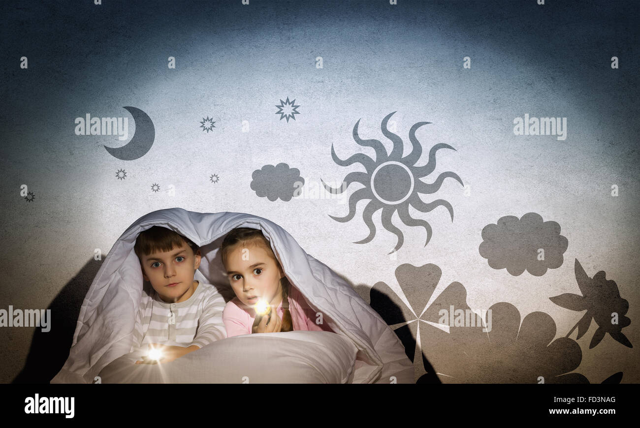 Children sitting in bed under blanket with flashlights Stock Photo - Alamy