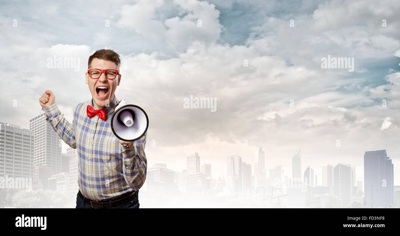 Young funny man screaming emotionally in megaphone Stock Photo - Alamy