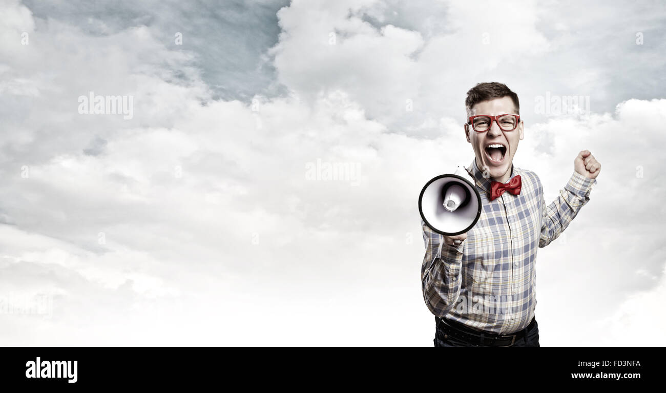 Young funny man screaming emotionally in megaphone Stock Photo - Alamy