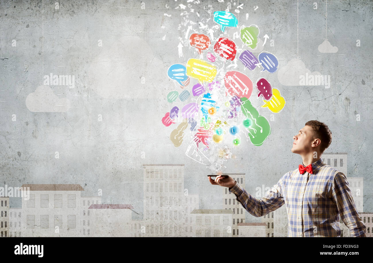 Young man with mobile phone and colorful chat icons Stock Photo - Alamy