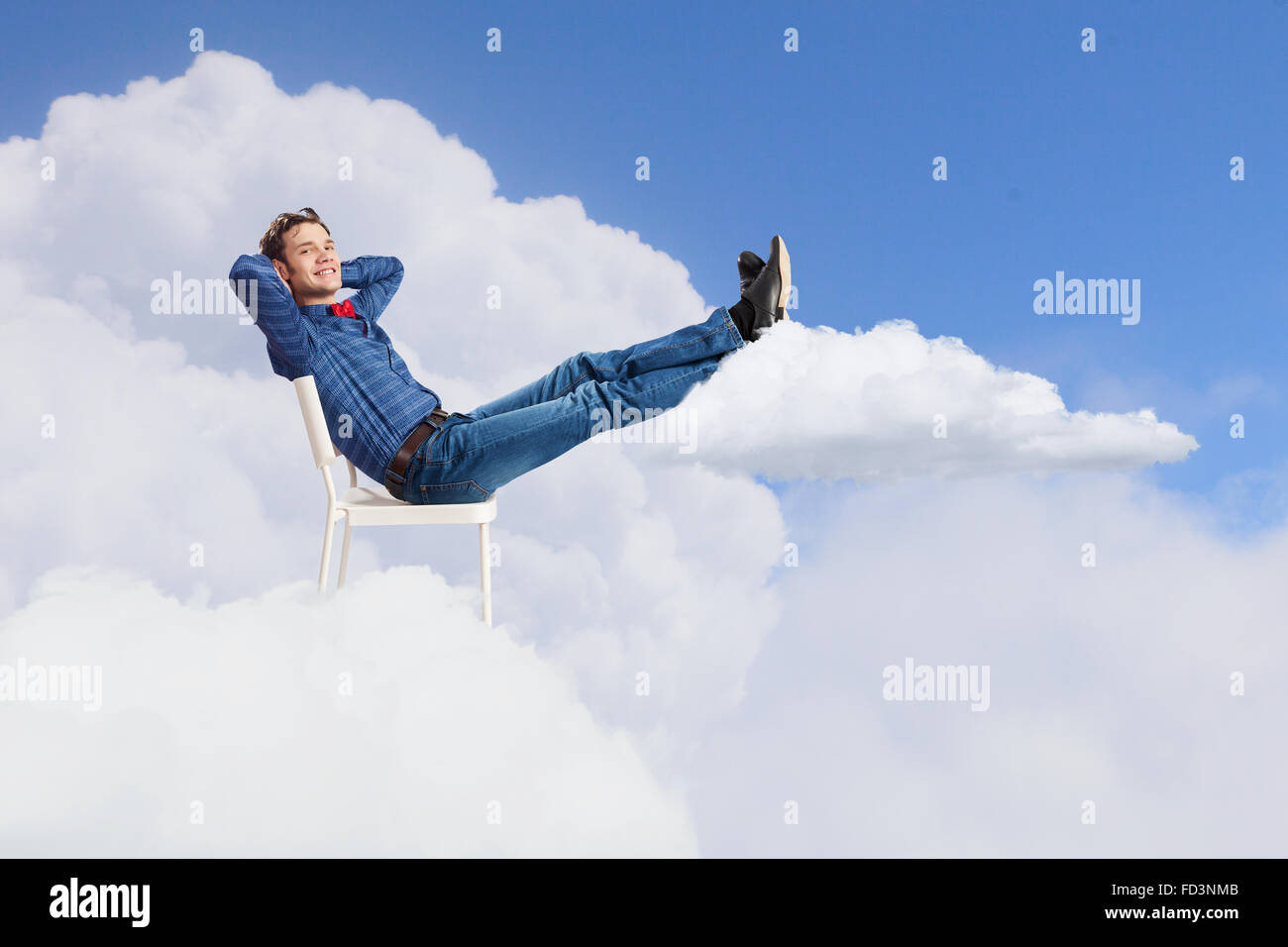 Young man sitting in chair with legs up and relaxing Stock Photo - Alamy