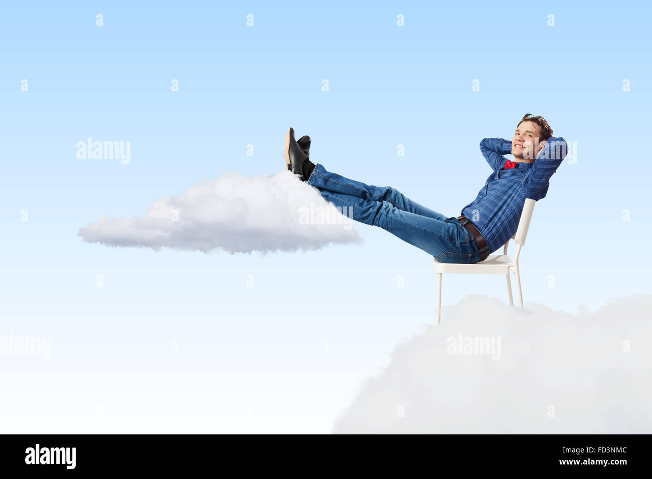 Young man sitting in chair with legs up and relaxing Stock Photo - Alamy