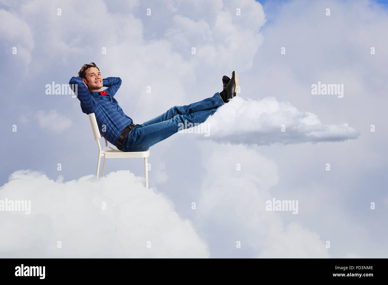 Young man sitting in chair with legs up and relaxing Stock Photo - Alamy