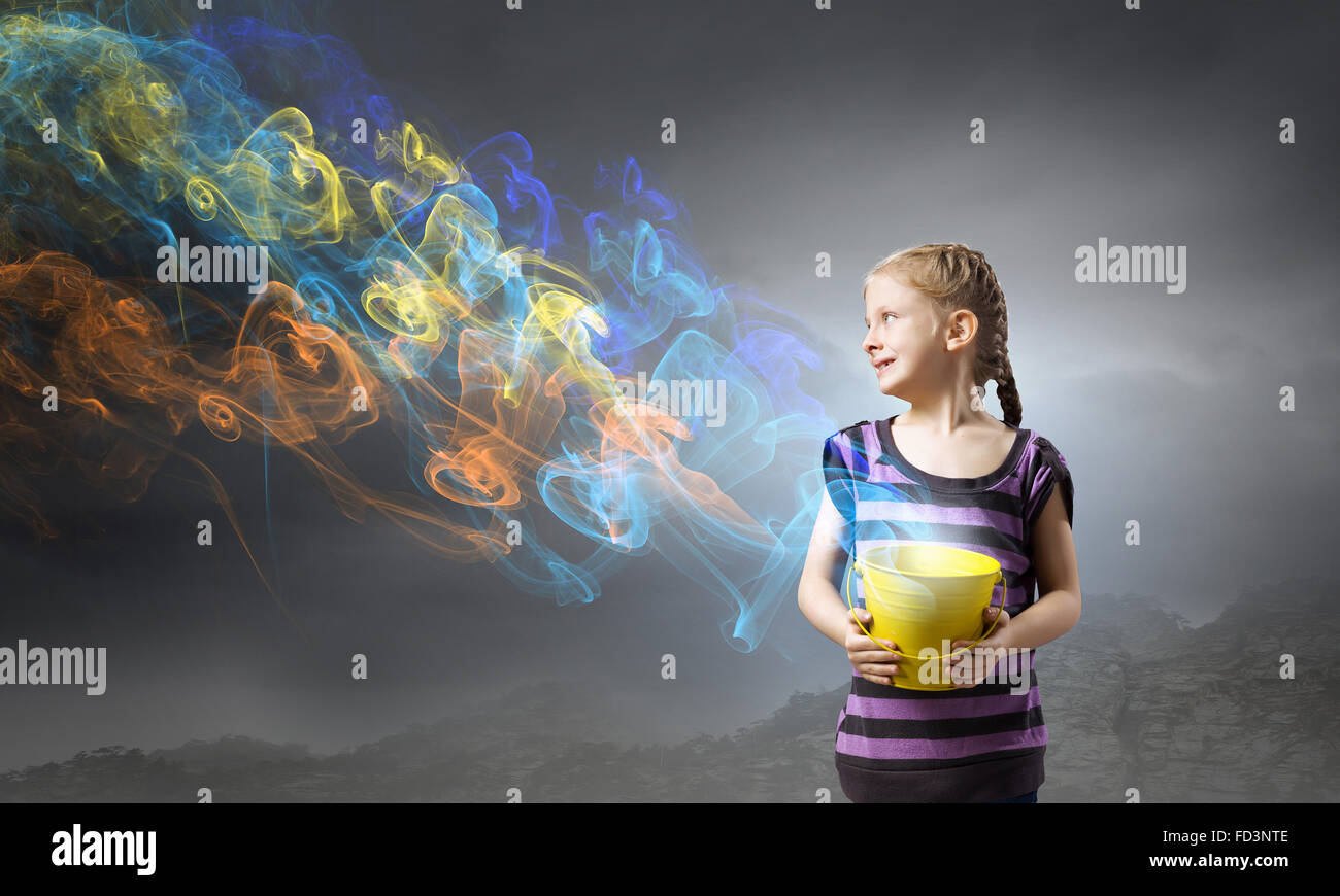 Cute girl with bucket and colorful springs coming out Stock Photo - Alamy