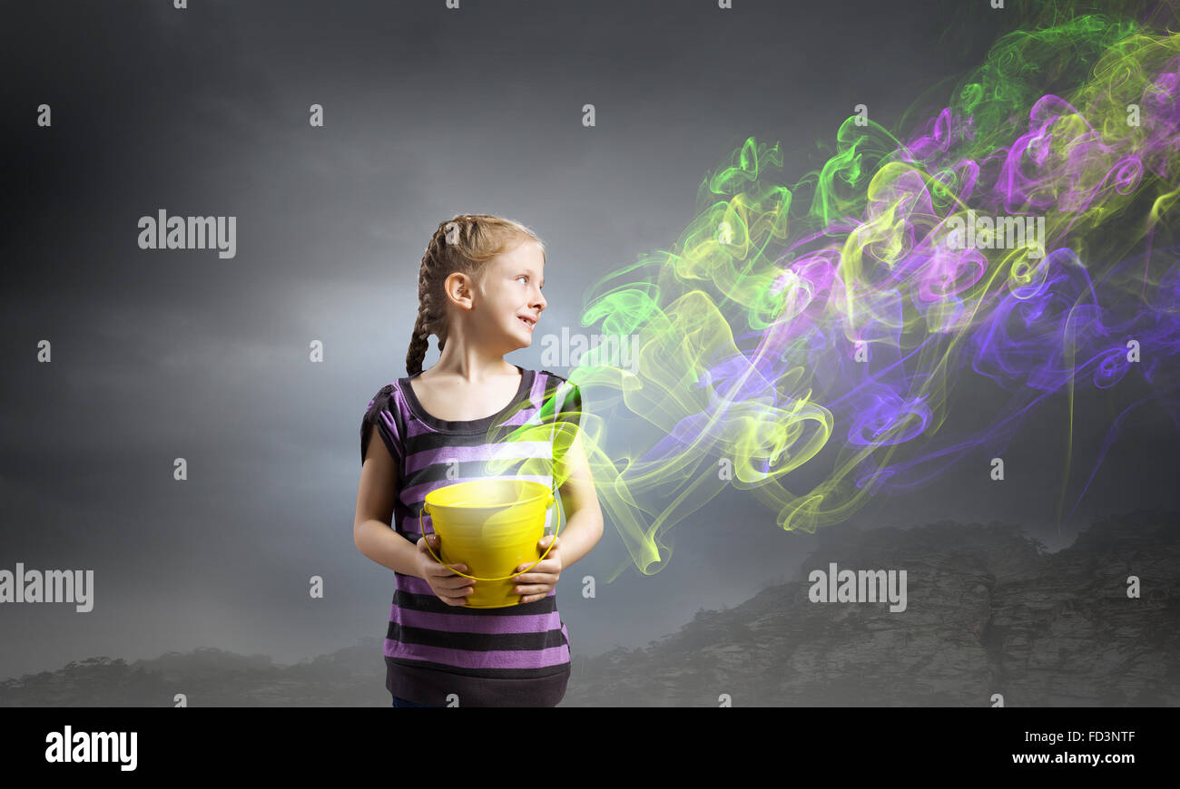 Cute girl with bucket and colorful springs coming out Stock Photo - Alamy