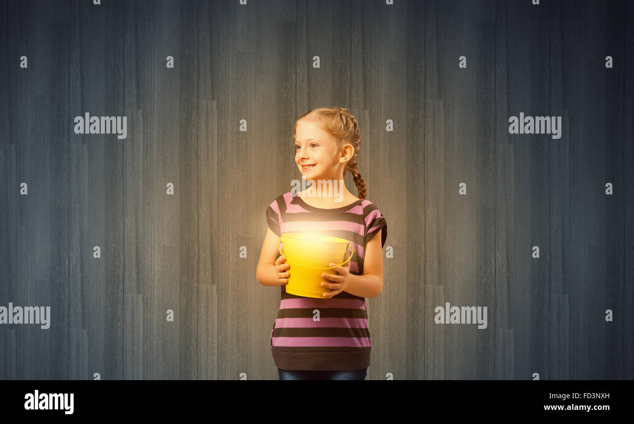 Cute girl with bucket trying to catch the sun Stock Photo - Alamy