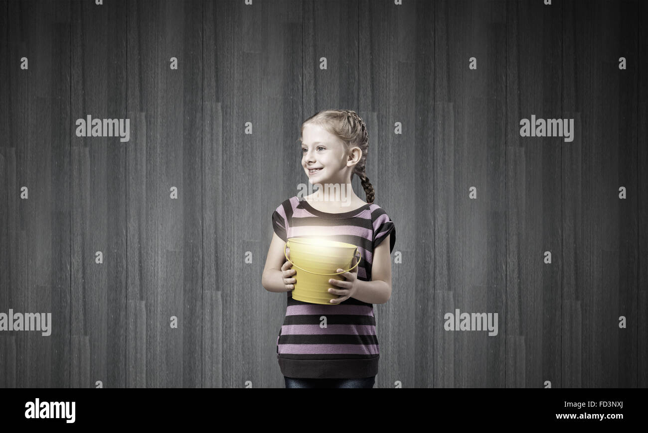 Cute girl with bucket trying to catch the sun Stock Photo - Alamy