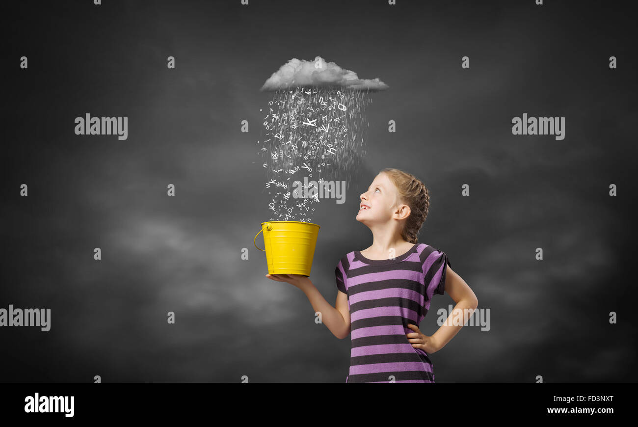 Little cute girl catching pouring characters with bucket Stock Photo ...