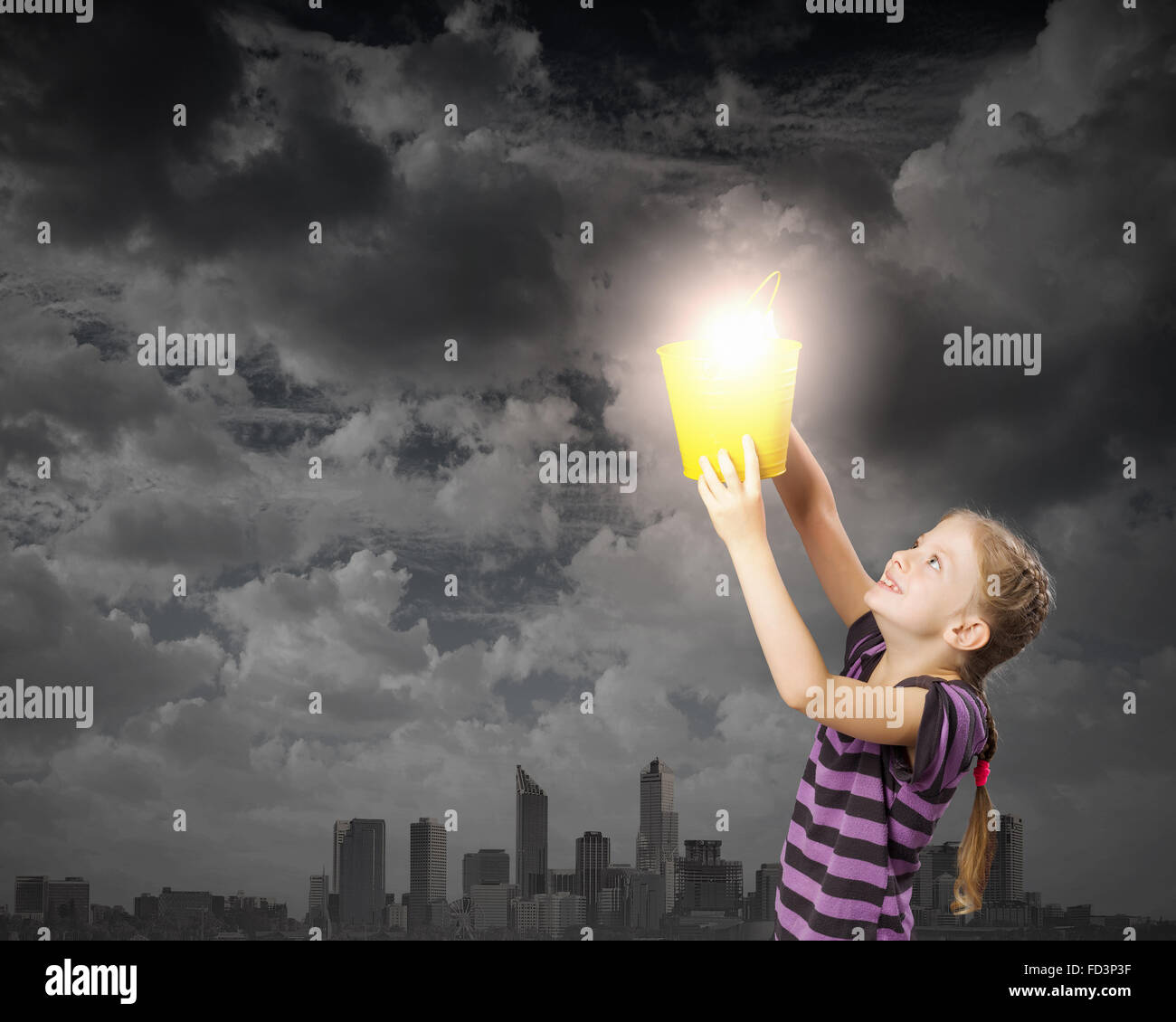 Cute girl with bucket trying to catch the sun Stock Photo - Alamy