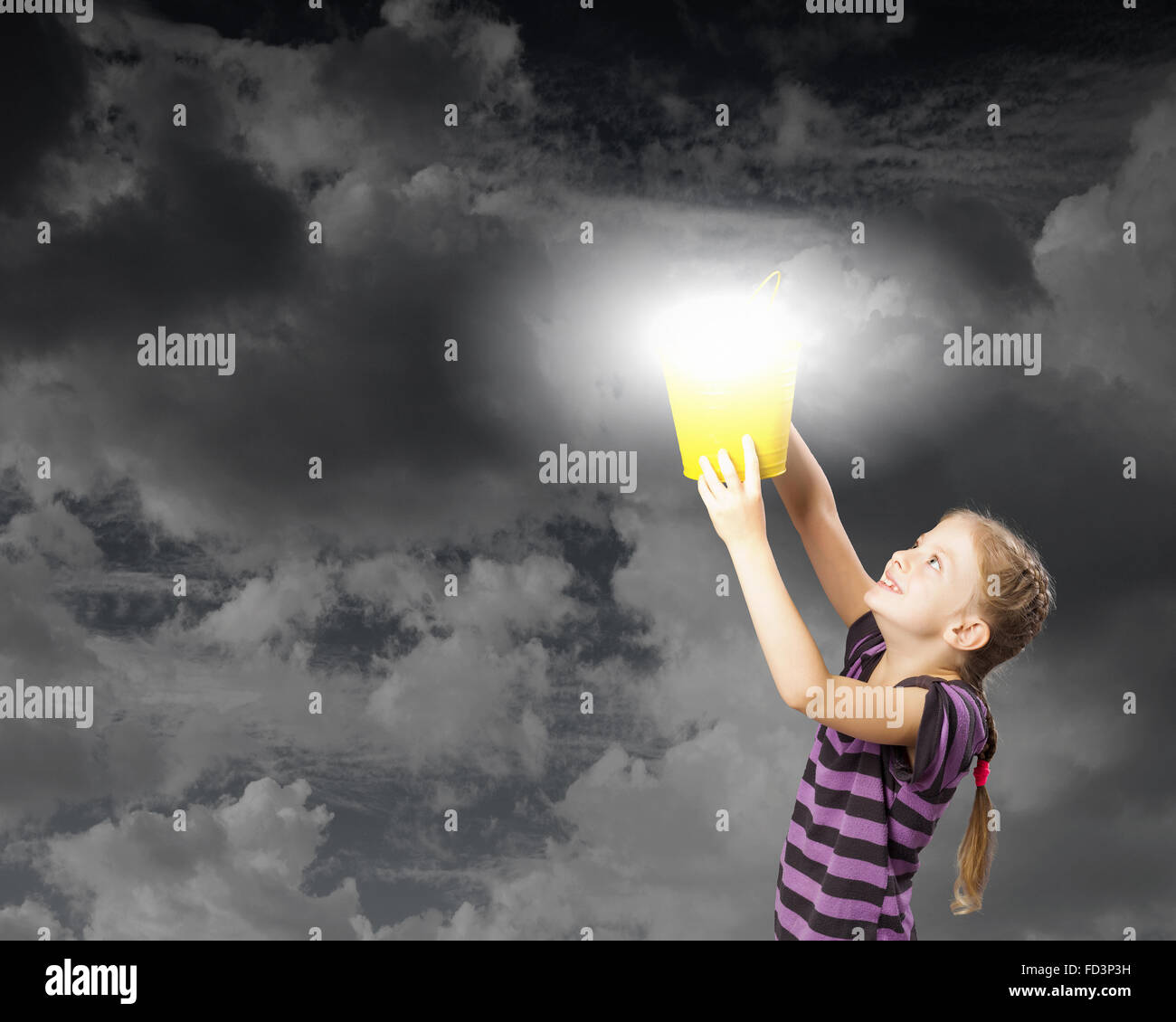 Cute girl with bucket trying to catch the sun Stock Photo - Alamy