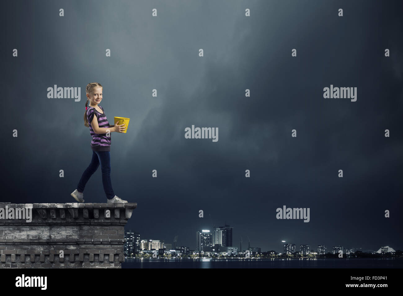 Cute girl with bucket trying to catch the sun Stock Photo - Alamy