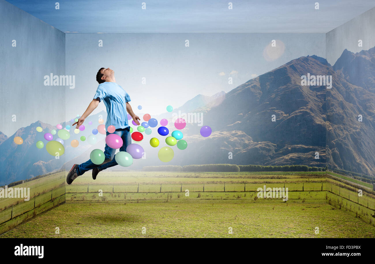 Young man jumping in sky in 3d room Stock Photo - Alamy
