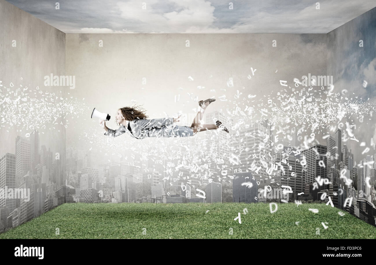 Young woman with megaphone flying in sky and announcing something Stock ...