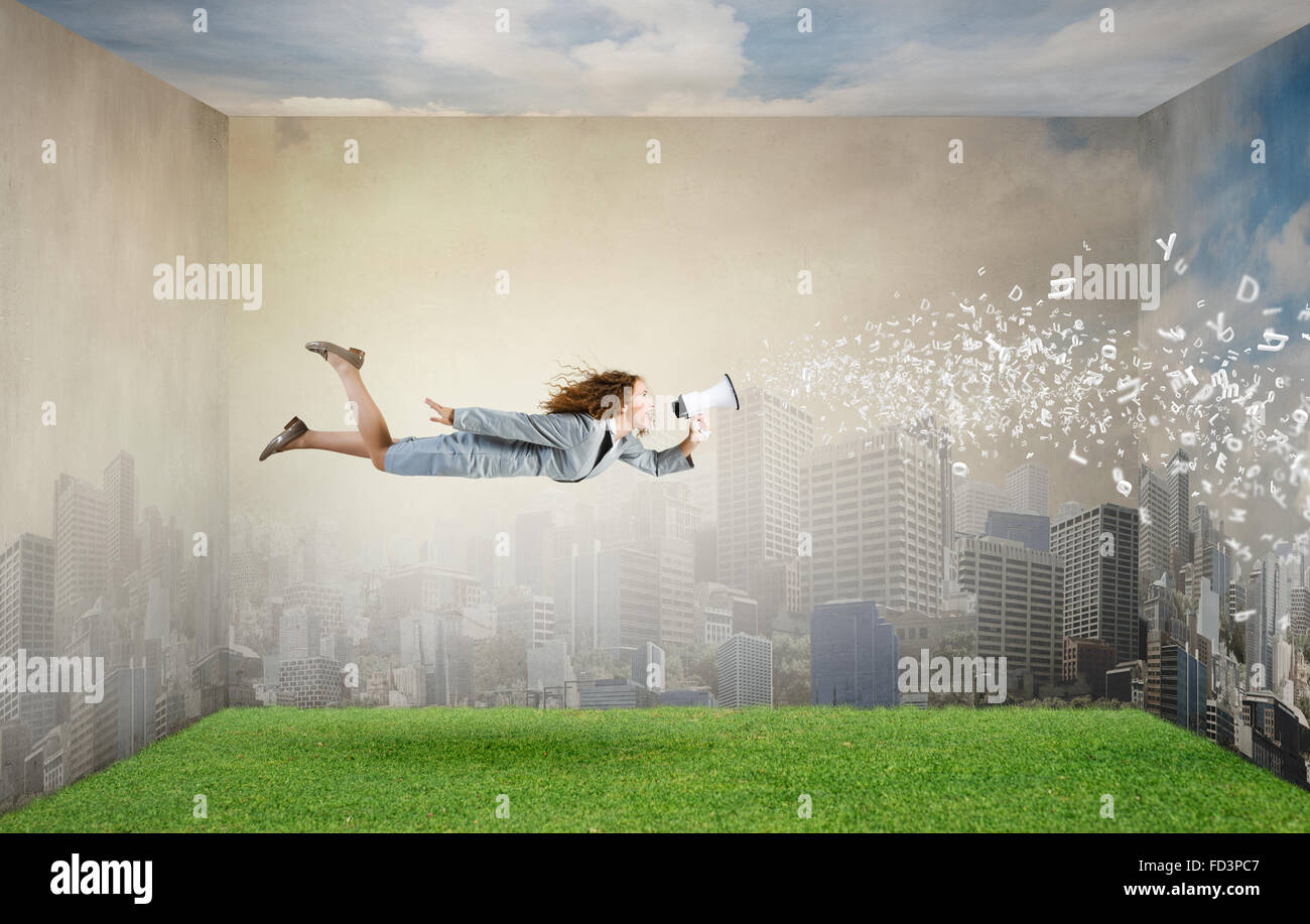 Young woman with megaphone flying in sky and announcing something Stock ...