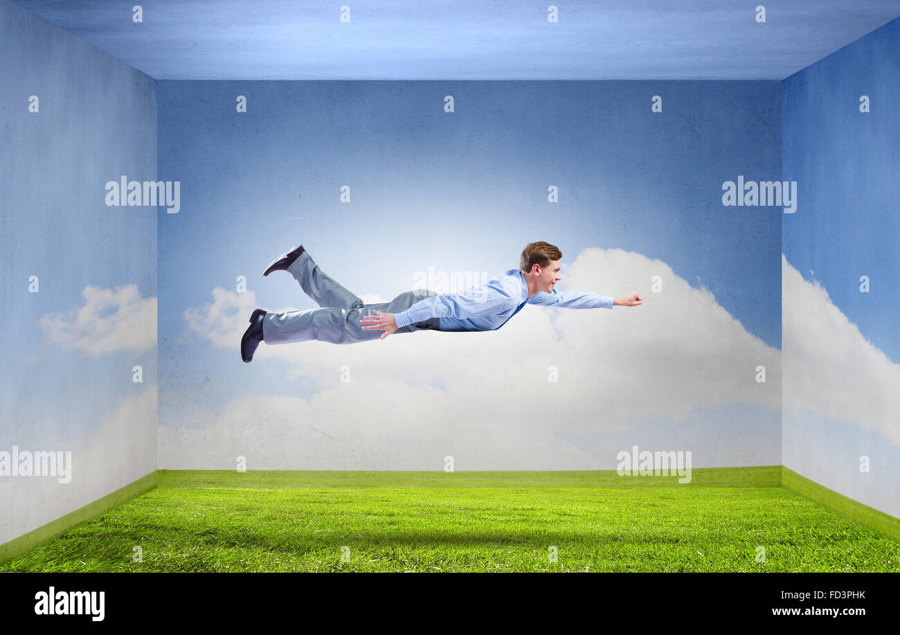 Young man flying in sky among flying around papers Stock Photo - Alamy