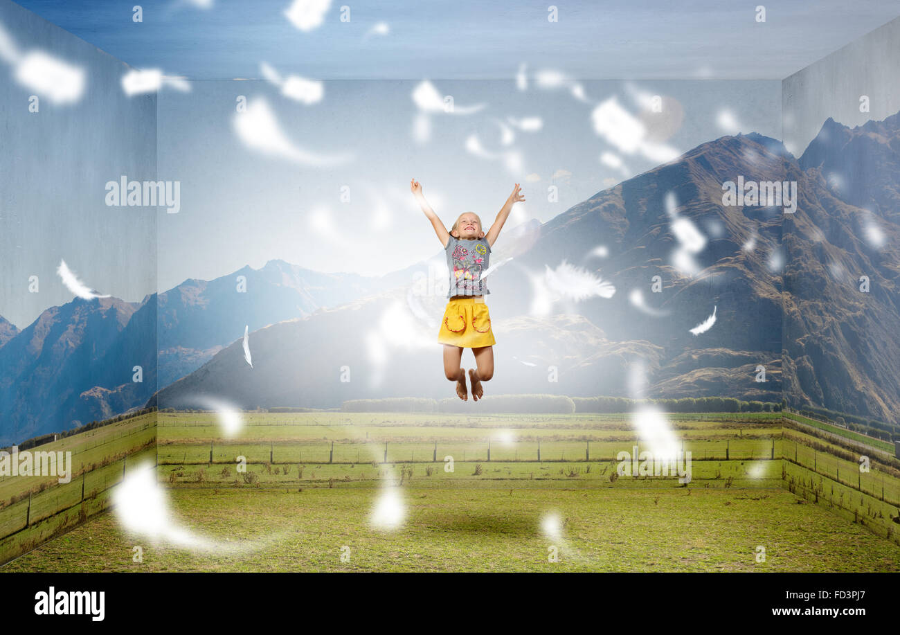 Little cute girl jumping high among feathers flying in sky Stock Photo ...
