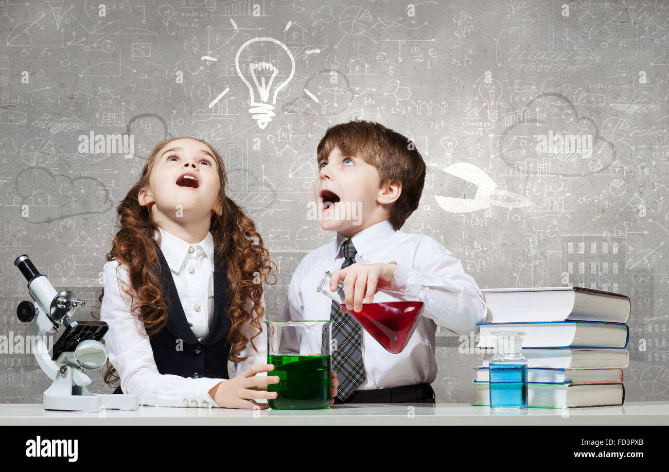 Two cute children at chemistry lesson making experiments Stock Photo ...