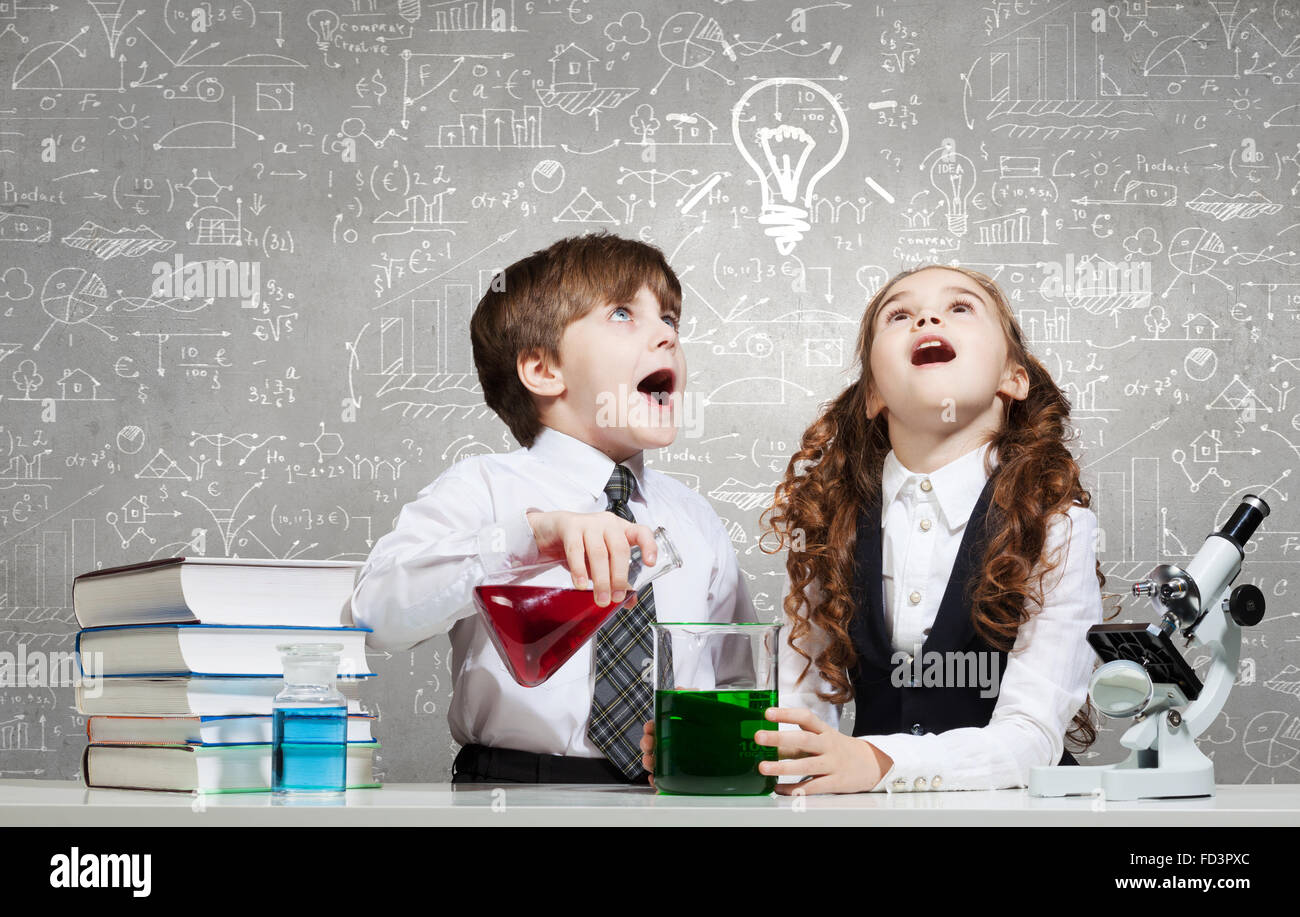 Two cute children at chemistry lesson making experiments Stock Photo ...
