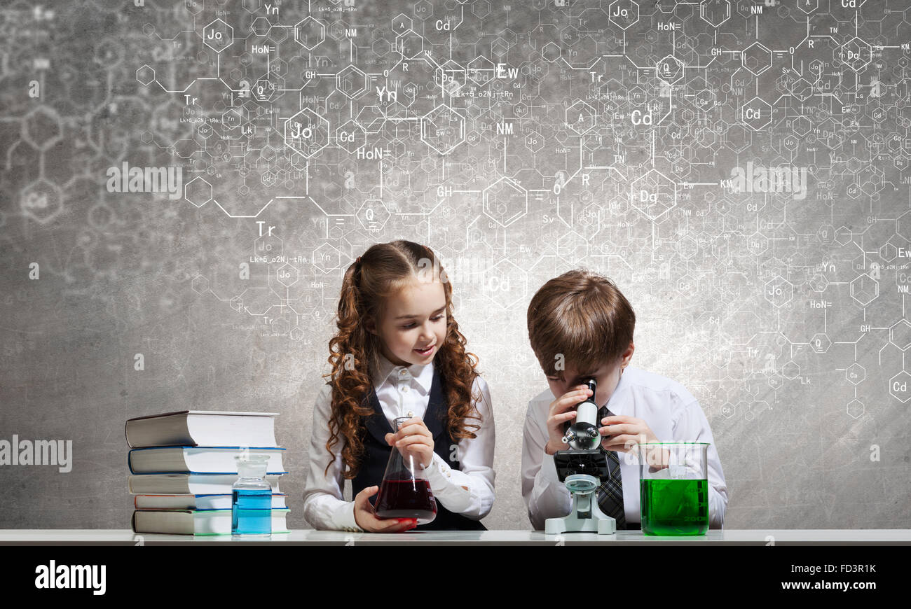 Two cute children at chemistry lesson making experiments Stock Photo ...