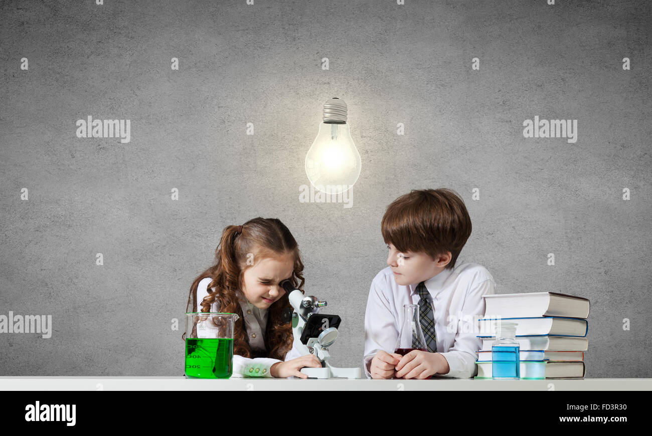 Two cute children at chemistry lesson making experiments Stock Photo ...