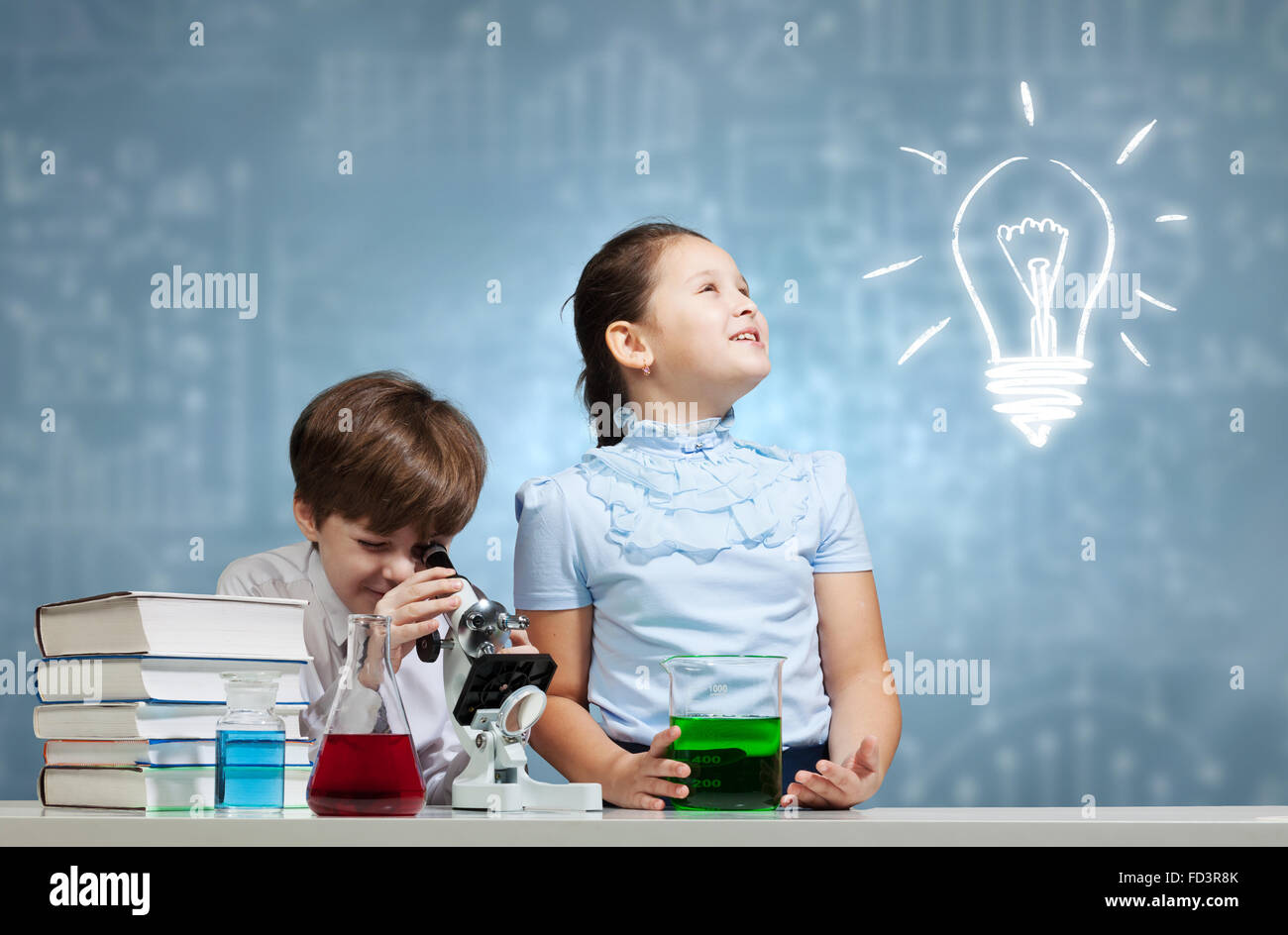 Two cute children at chemistry lesson making experiments Stock Photo ...