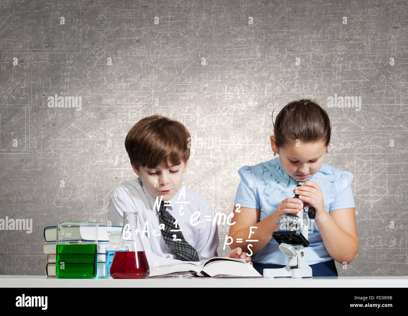 Two cute children at chemistry lesson making experiments Stock Photo ...