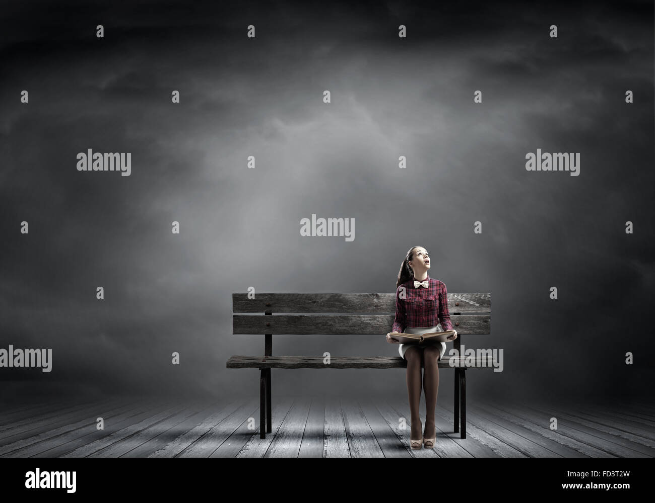 Young beautiful lady sitting on bench and reading book Stock Photo - Alamy