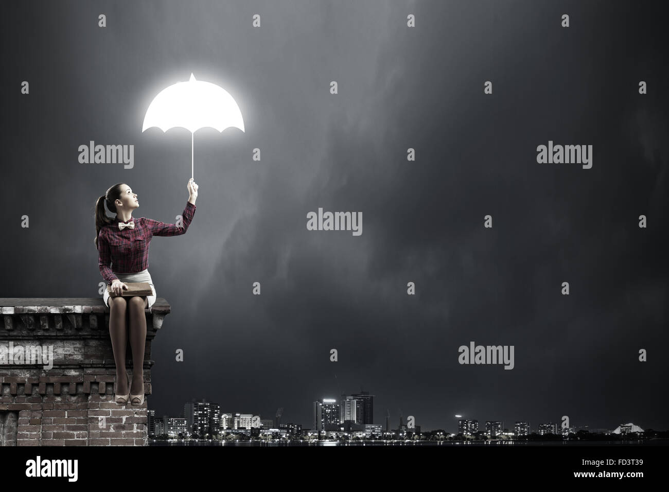 Young beautiful lady sitting on building roof and reading book Stock ...