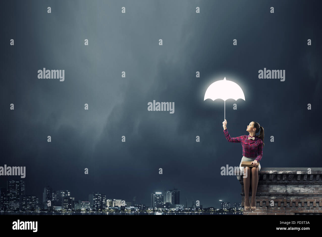 Young beautiful lady sitting on building roof and reading book Stock ...