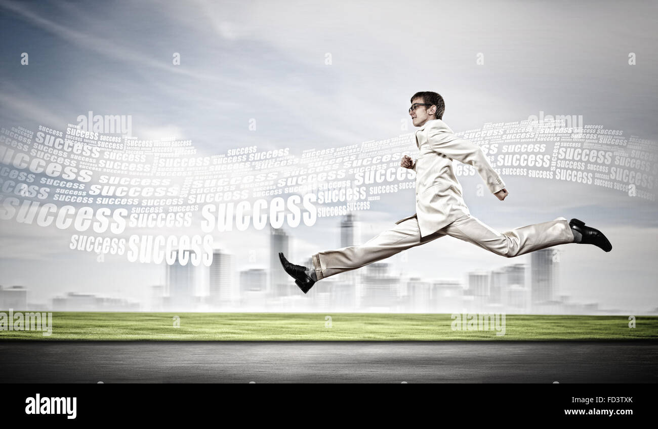 Young businessman in suit running on the road Stock Photo - Alamy
