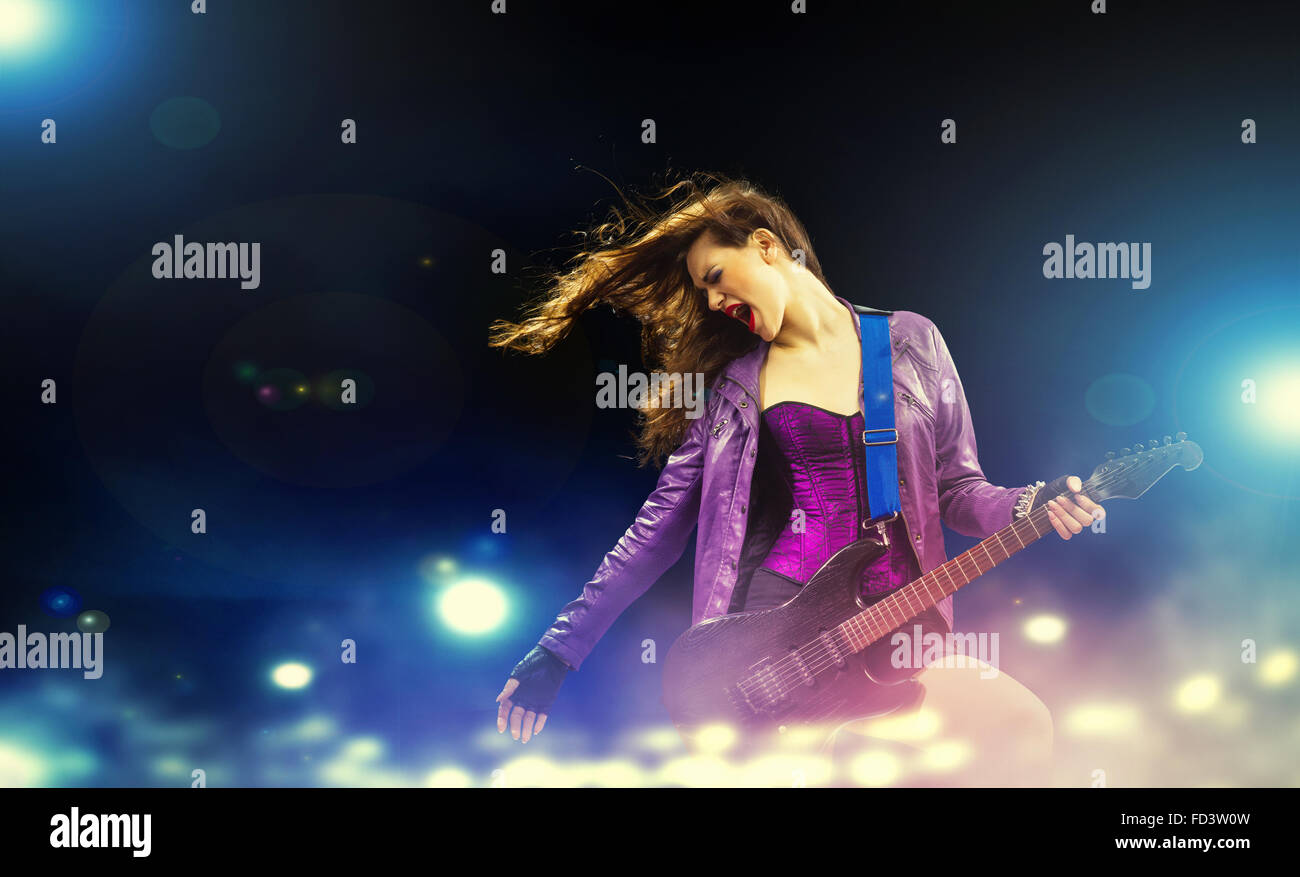 Young attractive rock girl playing the electric guitar Stock Photo - Alamy