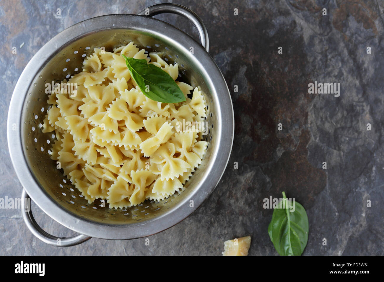 fresh bow pasta top view with basil and cheese Stock Photo - Alamy