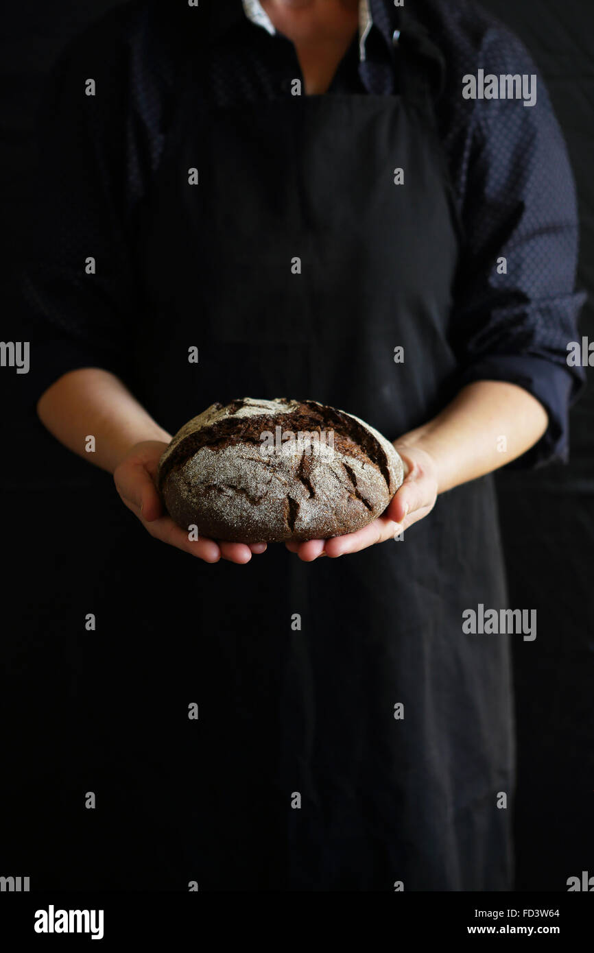 round dark bread in woman hands, food Stock Photo - Alamy