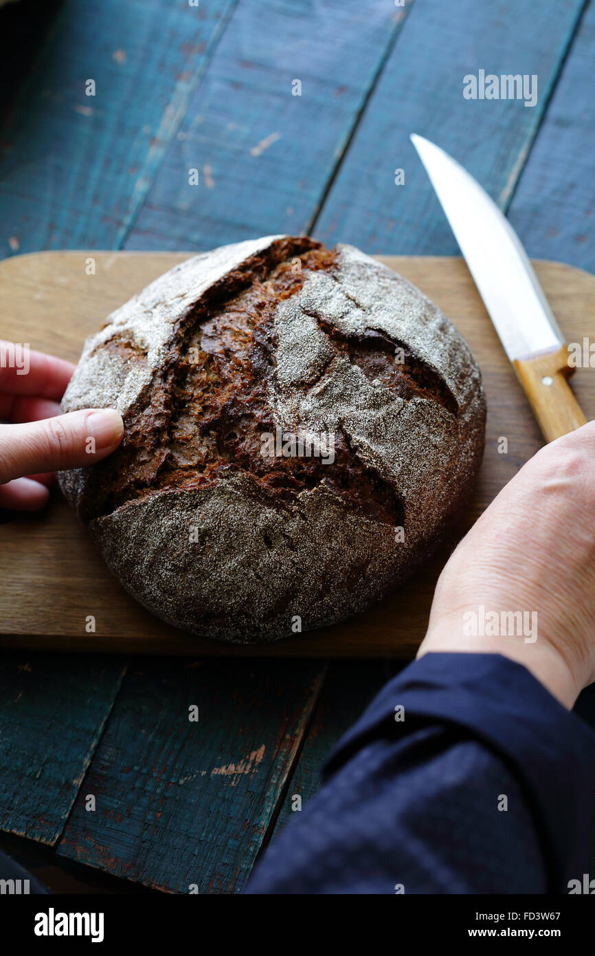 cutting loaf of rustic bread, food cooking Stock Photo - Alamy