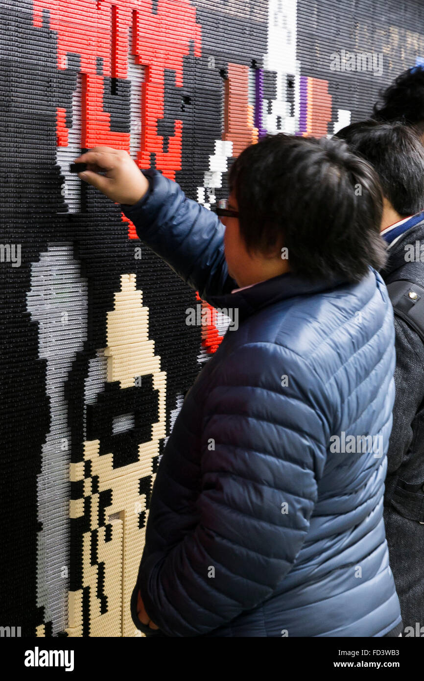 Dragon Quest fans collect blocks from a giant Lego wall mural on ...