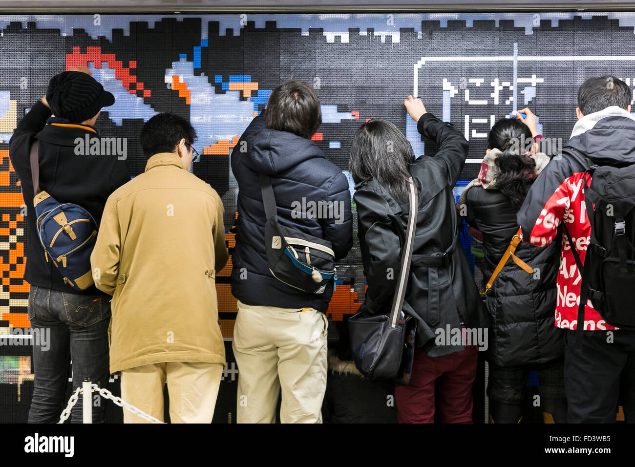 Dragon Quest fans collect blocks from a giant Lego wall mural on ...