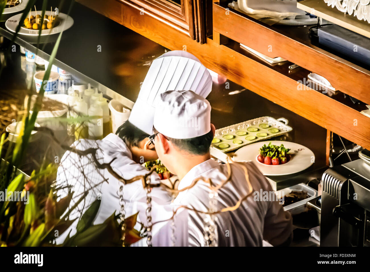 Chefs at work preparing cuisine Stock Photo - Alamy
