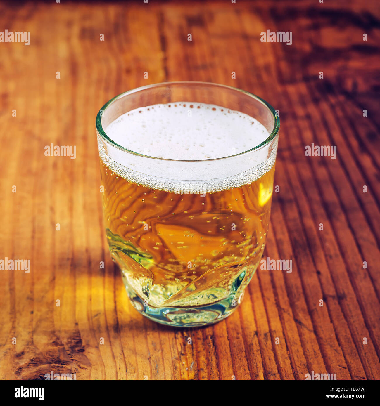 Apple cider beer in a glass on rustic wooden table Stock Photo - Alamy