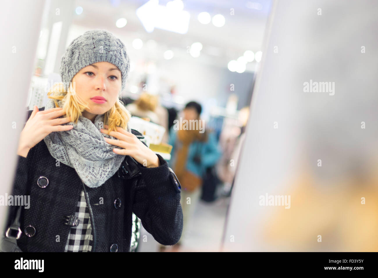 Beautiful woman shopping in clothing store Stock Photo - Alamy