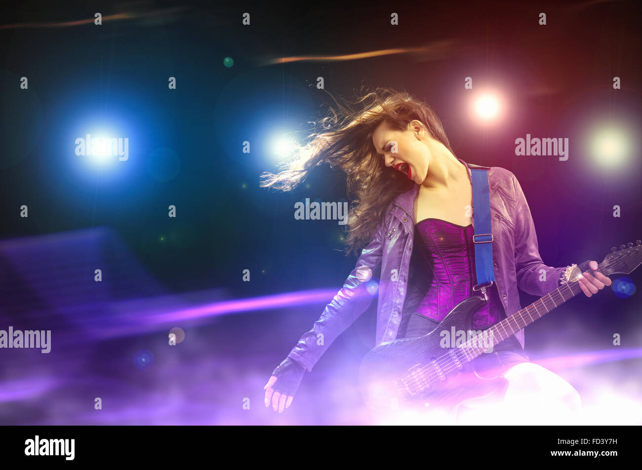 Young attractive rock girl playing the electric guitar Stock Photo - Alamy