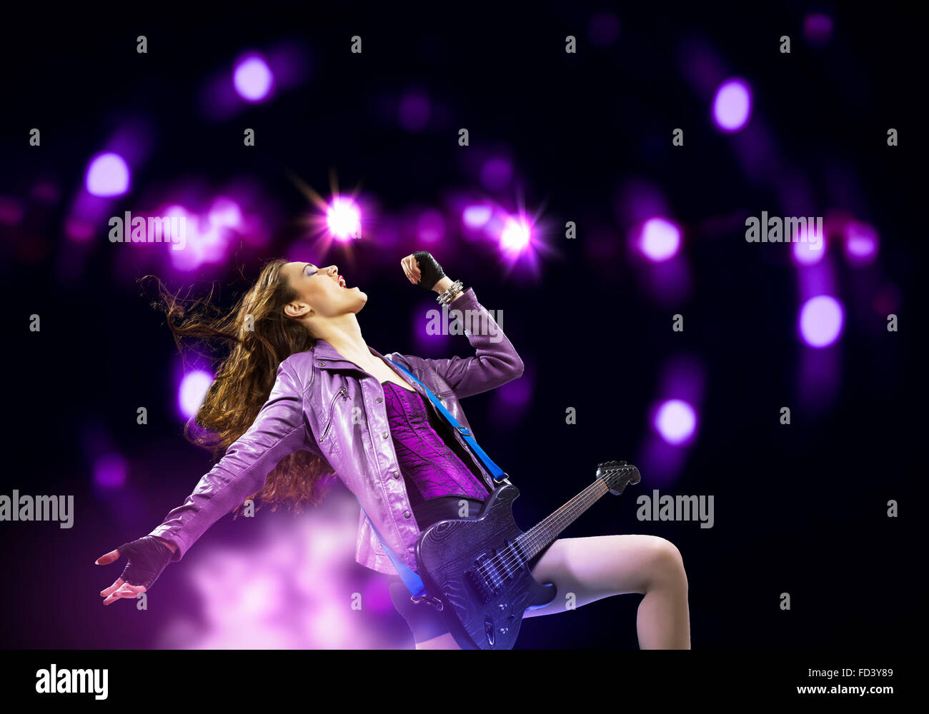 Young attractive rock girl playing the electric guitar Stock Photo - Alamy