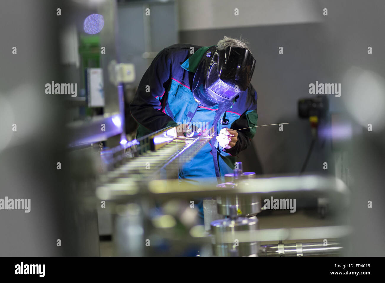 Industrial worker welding in metal factory Stock Photo - Alamy