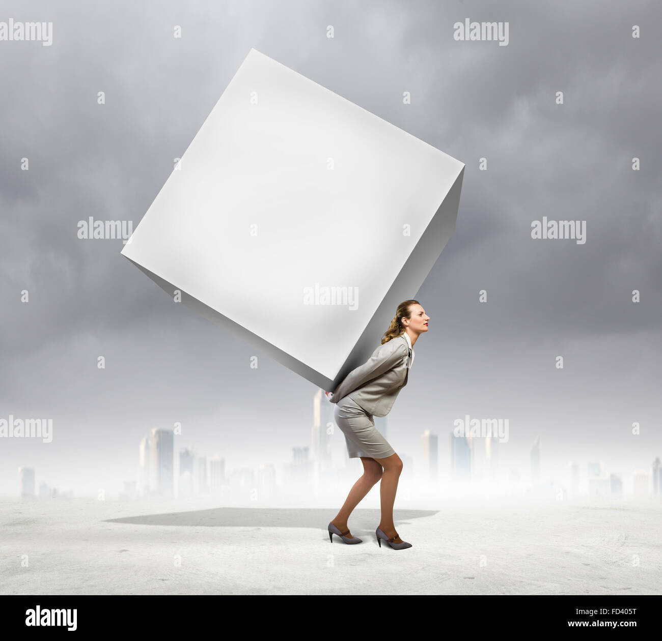Image of businesswoman carrying big white cube on her back. Place for ...