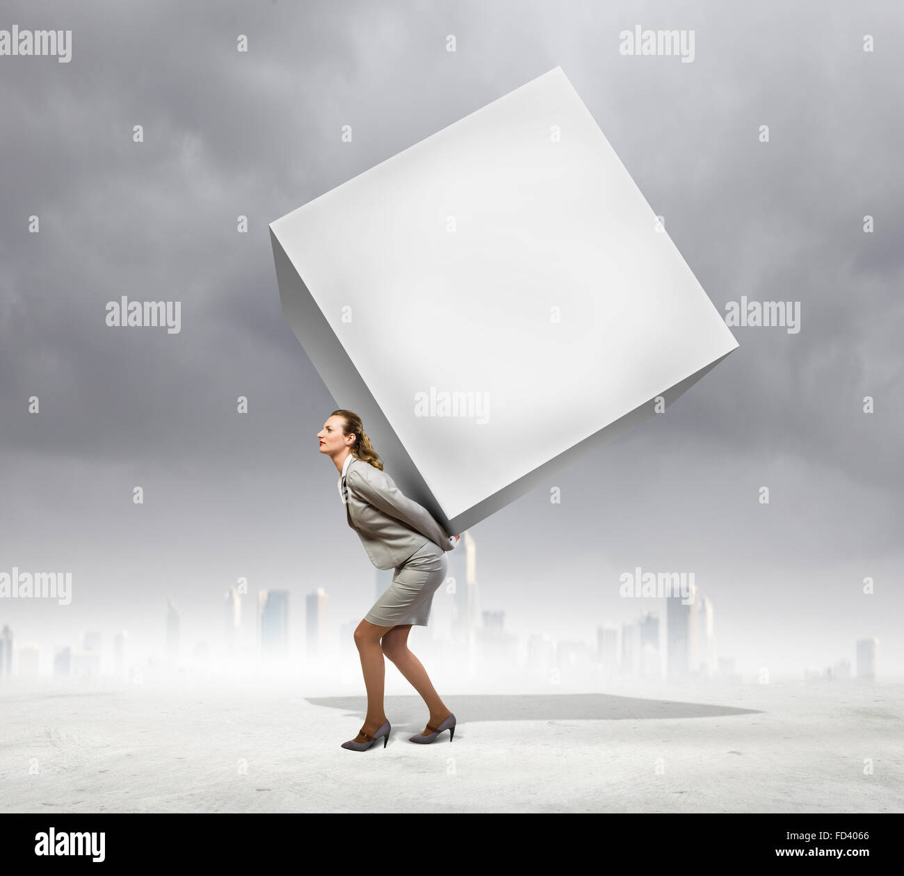 Image of businesswoman carrying big white cube on her back. Place for ...