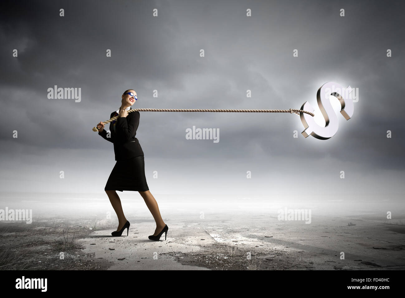 Image of businesswoman pulling dollar sign with rope Stock Photo - Alamy